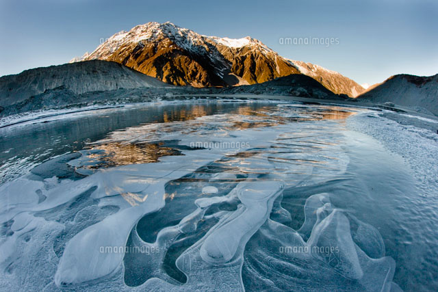 Ice bubbles in Mueller Lake with Mount Wakefield in backgrou ...