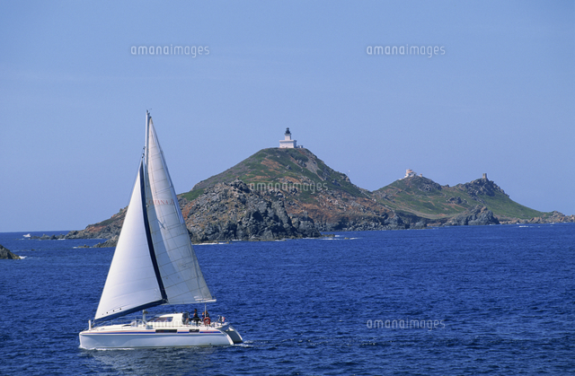 Sailing boat with the Semaphore Lighthouse behind, Iles Sanguinaires ...