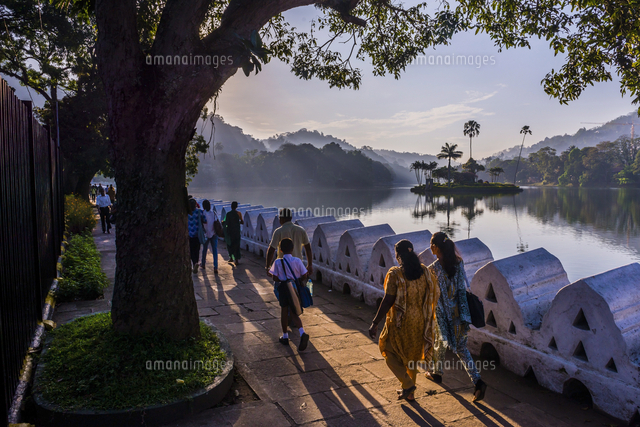 Sri Lankan people walking at Kandy Lake at sunrise, Kandy, Central ...