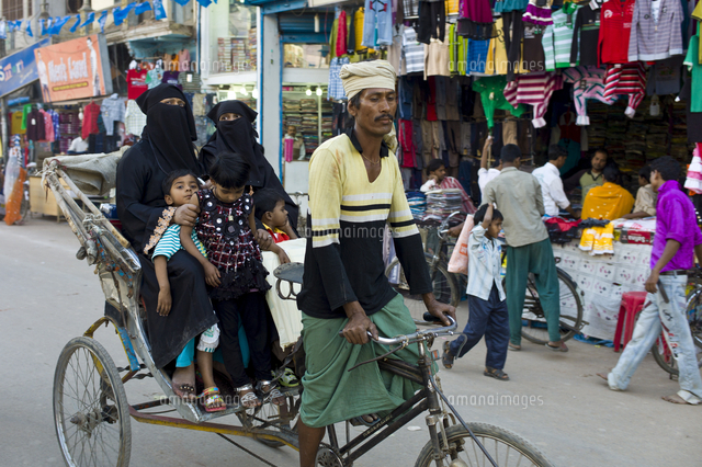 Street scene in holy city of Varanasi, young muslim women in black ...