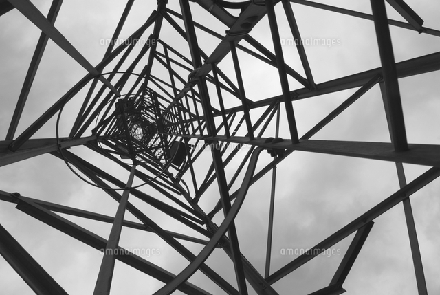 Looking up through rusty pylon to give spiders web feel to image, with ...
