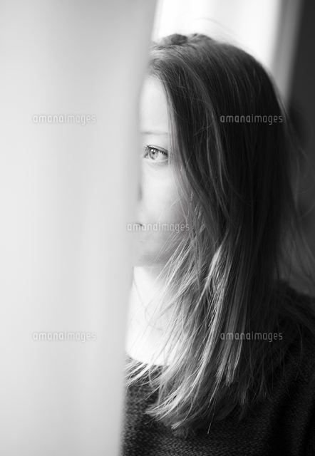 Young woman looking out of window[20071010365]の写真素材・イラスト素材｜アマナイメージズ