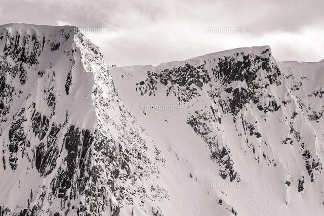 Three skiers ready for freeride descent, Golden, Alberta, British ...