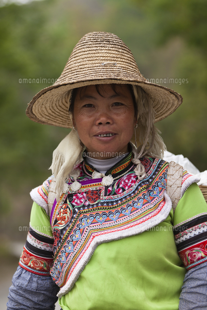 China, Yunnan, Yuanyang. A Hani lady returning from planting rice ...