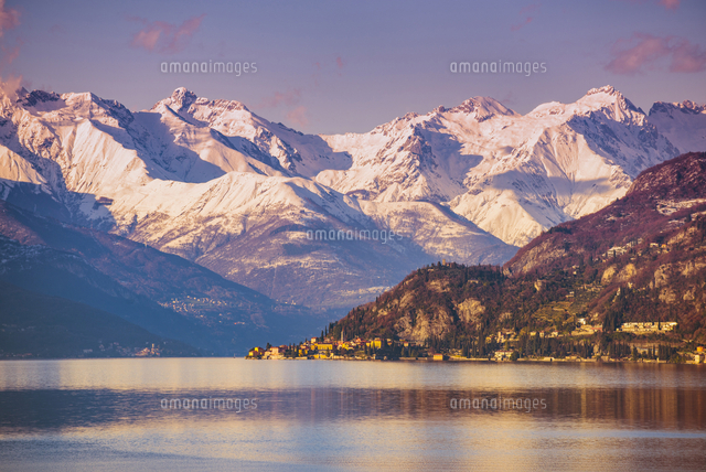 Varenna, Lecco, Lombardy, Italy. A winter sunset over Varenna with snow ...