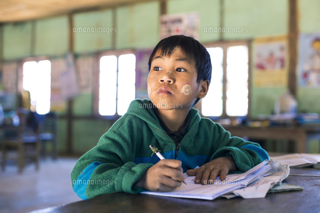 Myanmar, Chin State, Kempetlet. Child writing on his exercise book ...