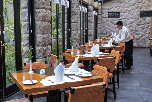 South America, Peru, Machu Picchu, a waiter setting a table in the ...