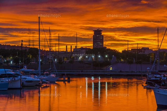 View of Port Vell harbor at sunset with dramatic red sky, Barcelona ...