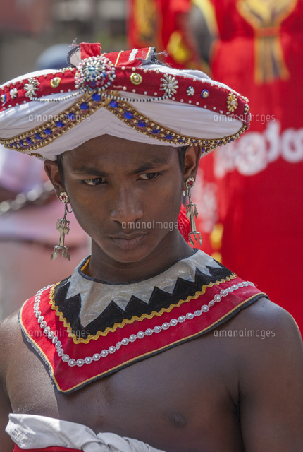 A Kandyan drummer dressed in traditional attire ready to participate in ...