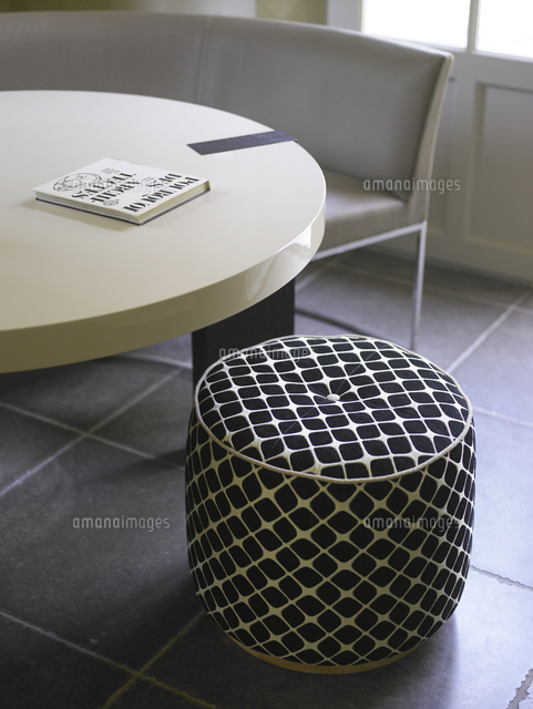 Table with patterned footstool in barn conversion, France[25937008803]の ...