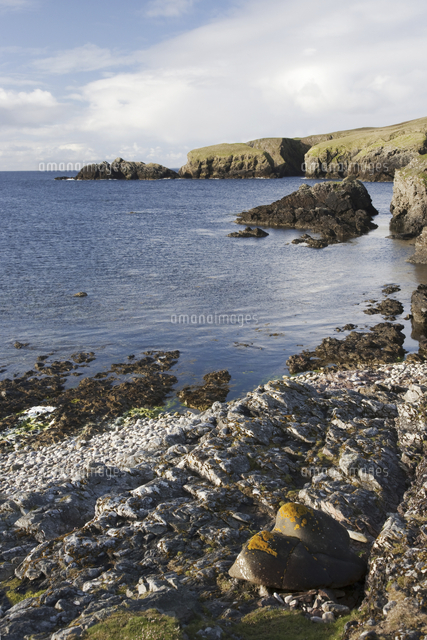 View of rocky beach and cliffs, Funzie Bay, Fetlar, Shetland ...