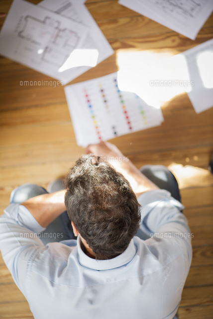 Man contemplating blueprints and color swatches[11001064832]の写真素材・イラスト ...