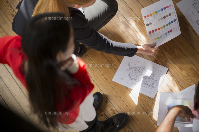 Designers discussing blueprint and color swatches[11001064838]の写真素材 ...
