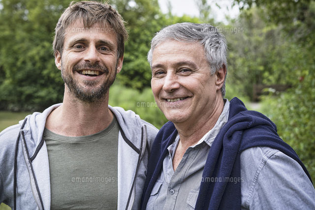 Father and son standing in garden[11001072816]の写真素材・イラスト素材｜アマナイメージズ