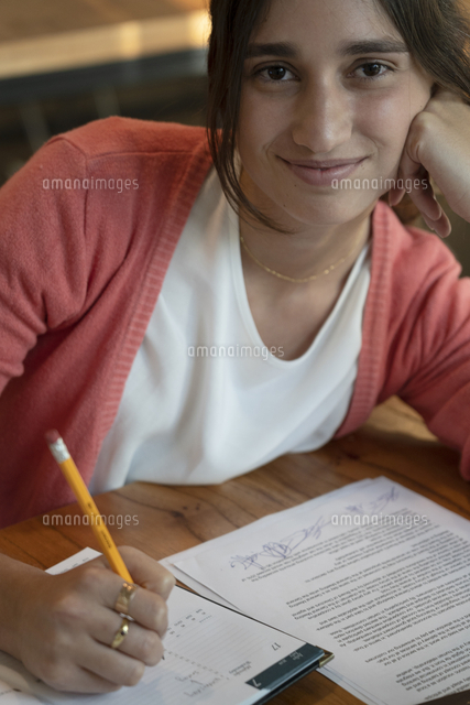 Portrait of young woman working in office[11001074453]の写真素材・イラスト素材｜アマナイメージズ
