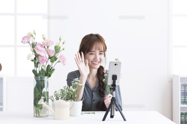 Young pretty woman smiling waving and broadcasting a live video ...