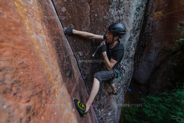 Rock climber climbing sandstone rock, elevated view, Liming, Yunnan ...
