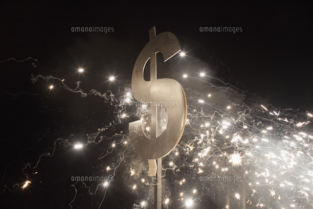 Illuminated dollar symbol with fireworks at night[11016029831]の写真素材 ...