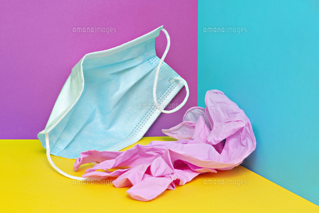 Crumpled face mask and plastic gloves on colorful background ...