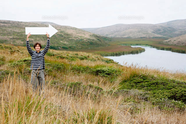 Man holding direction arrow[11021001252]の写真素材・イラスト素材｜アマナイメージズ