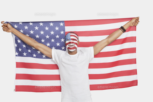 Portrait of Young man with American flag and painted face against white ...