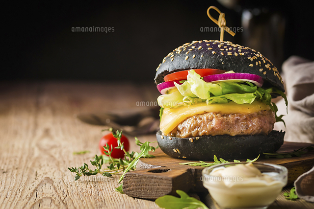 Tasty grilled classic beef black burger with lettuce and mayonnaise ...