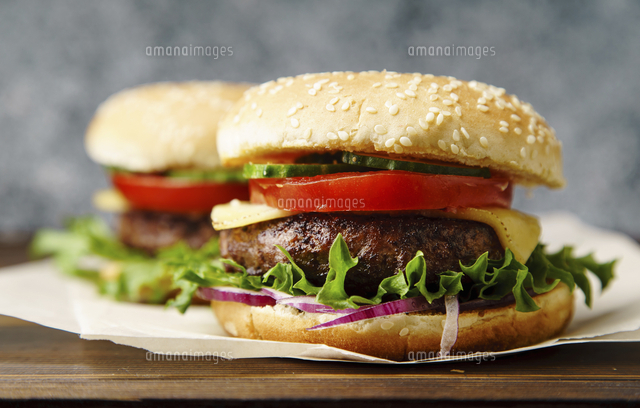 Classical burger with grilled meat, tomatoes, cheese, onion, cucumber ...