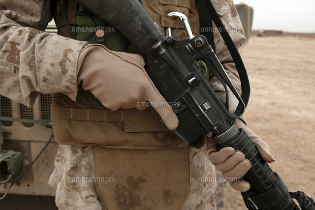A Marine displays the required hand personal protective equi ...