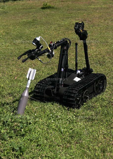 The Talon bomb disposal robot picks up an inert unexploded m ...