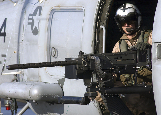 Soldier mans a .50 caliber machine gun on an SH-60 Seahawk.[11079019529 ...