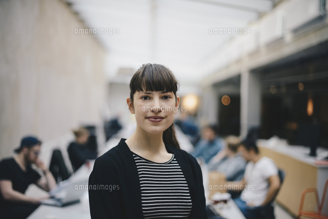 Portrait of female confident computer programmer at office with ...