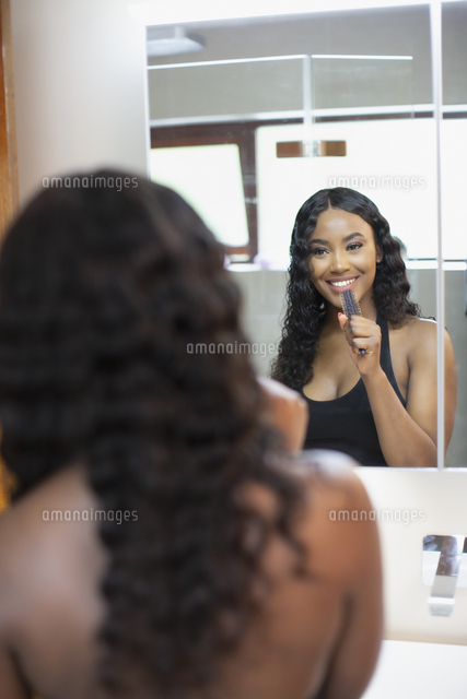Happy young woman singing with hairbrush in bathroom mirror[11086056813 ...