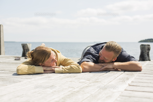 Sweden, Stockholm Archipelago, Grasko, Mature couple relaxing on jetty ...