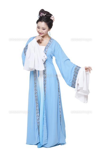 Young woman in Chinese traditional costume showing a shy loo ...