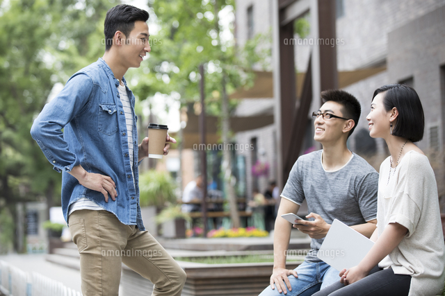 Cheerful young Chinese friends talking outdoors[11091026105]の写真素材・イラスト ...