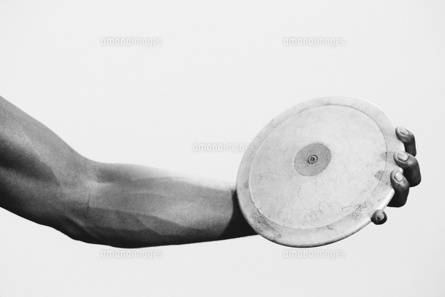 A female track and field athlete holding a discus in her hand ...