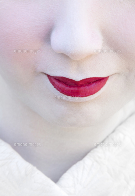 Close up of Geisha's face with traditional make up, pale white skin and ...