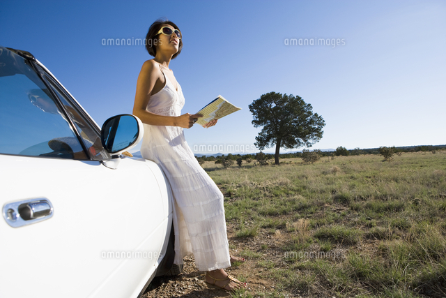 Native American woman in sun dress driving a white convertible sports ...