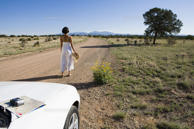 Native American woman in sun dress driving a white convertible sports ...