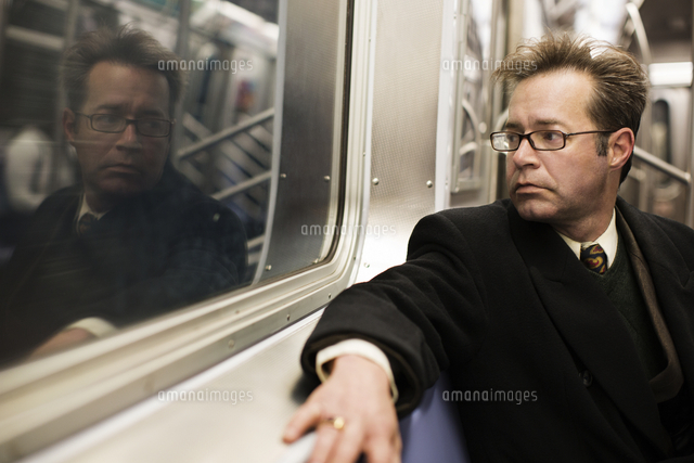 Portrait of man looking through window of subway train[11100013932]の写真 ...