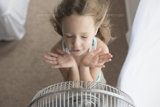High angle view of girl with eyes closed standing in front of windy ...