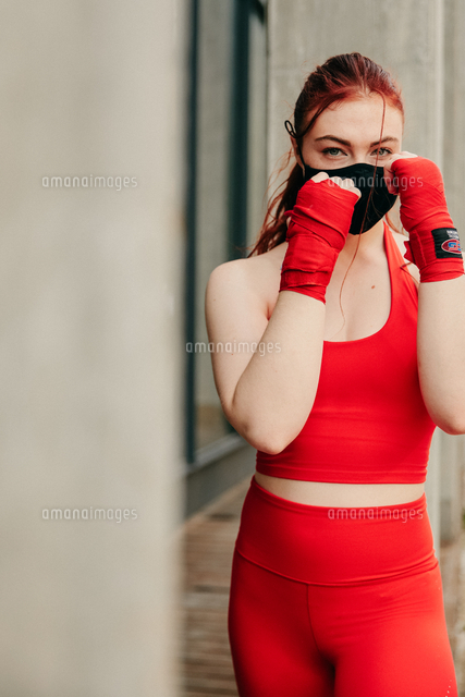 Young female boxer, training outdoors in Brooklyn wearing face-mask ...