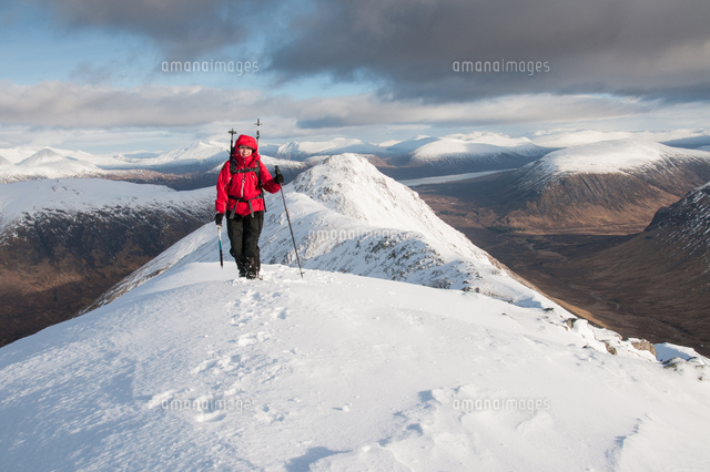 A female walker approaching the summit of Stob Dubh on Buchaille Etive ...