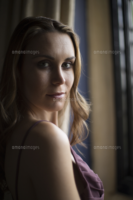 Portrait Of Beautiful Woman Standing By Window At Home[11115130539]の写真 ...