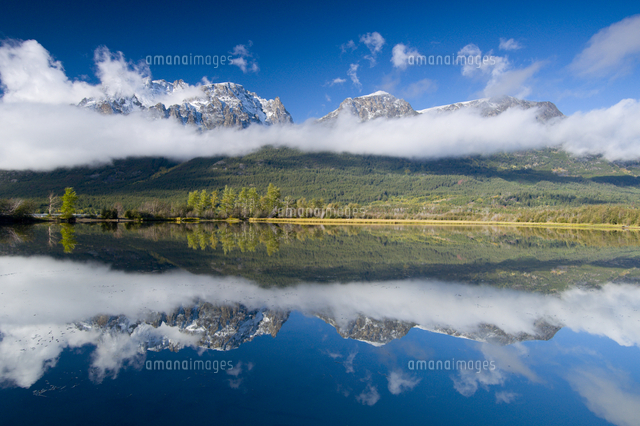 The Niut Range is reflected in the lagoon near the shores of Tatlayoko ...
