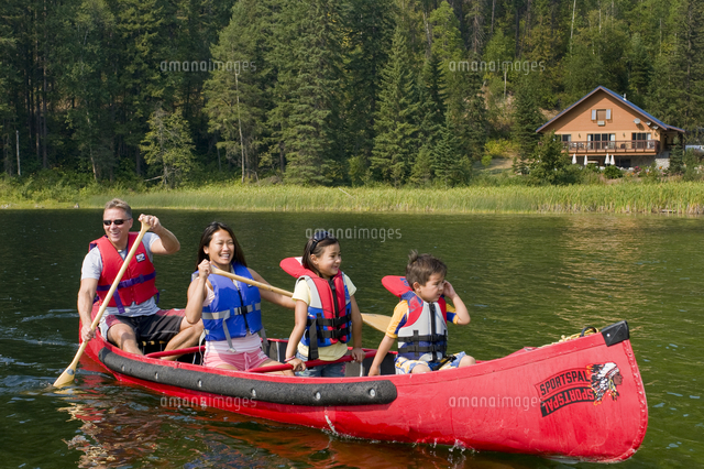 A family enjoys a canoe trip on a beautiful summer day at Hallamore ...