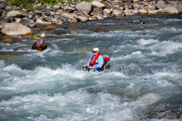 Man in raft, fly fishing, Copper River, British Columbia, Canada ...