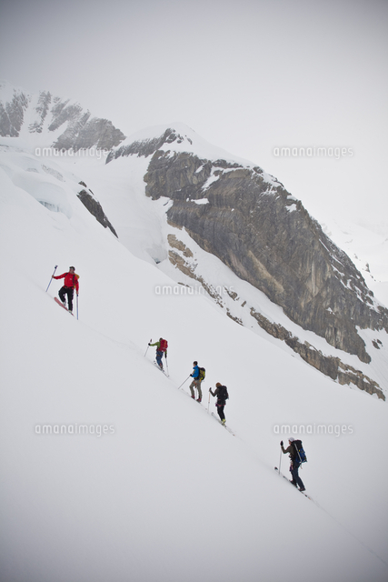 A group of people ski touring in the Canadian Rockies backcountry ...