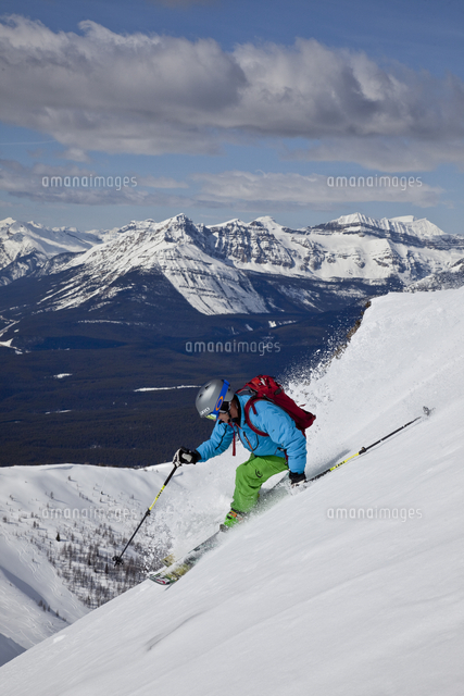 Young male skier skiing untracked slope at Lake Louise Ski Resort ...