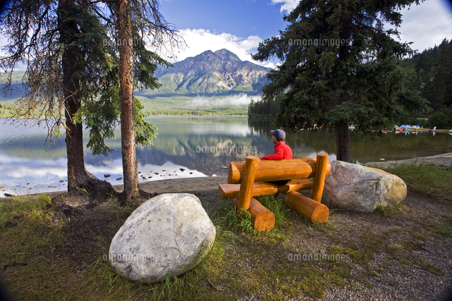 Middle age male sitting on bench at Pyramid Lake looking at Pyramid ...